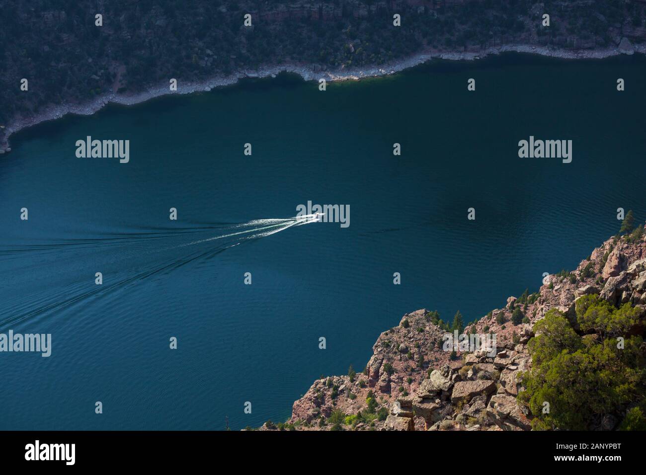 Aerial view of man wakeboarding on lake. Water skiing on lake behind a ...