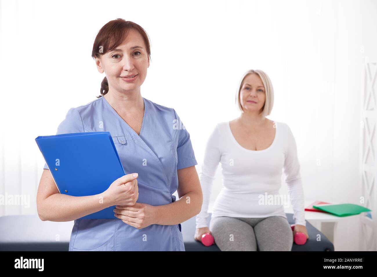 Female patient and doctor have consultation in hospital. Restoration ...