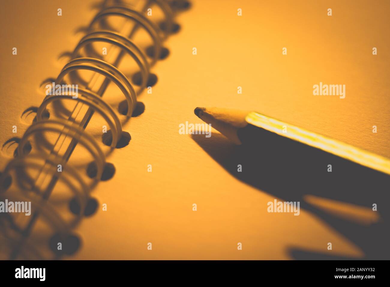 Pencil on pure orange spiral notebook paper, warm colors Stock Photo ...
