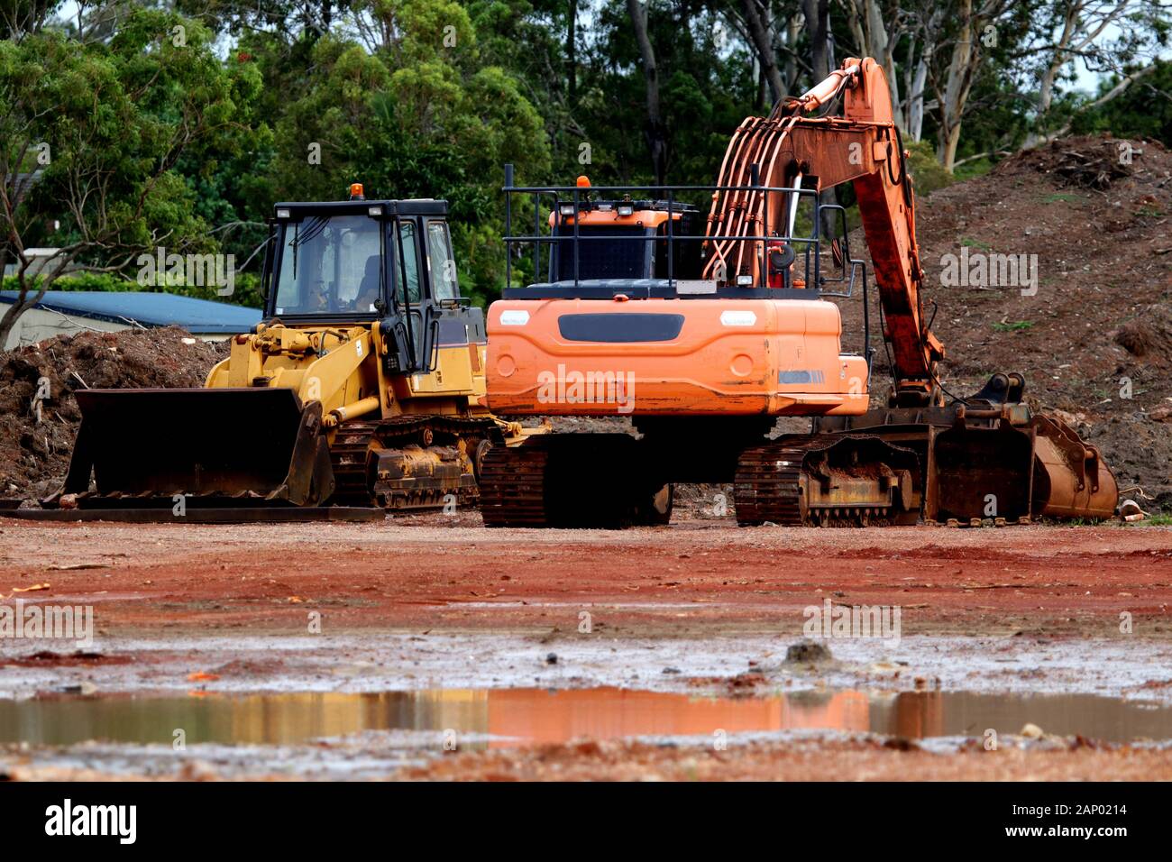 Construction machinery: diggers on a job site outside. A construction ...