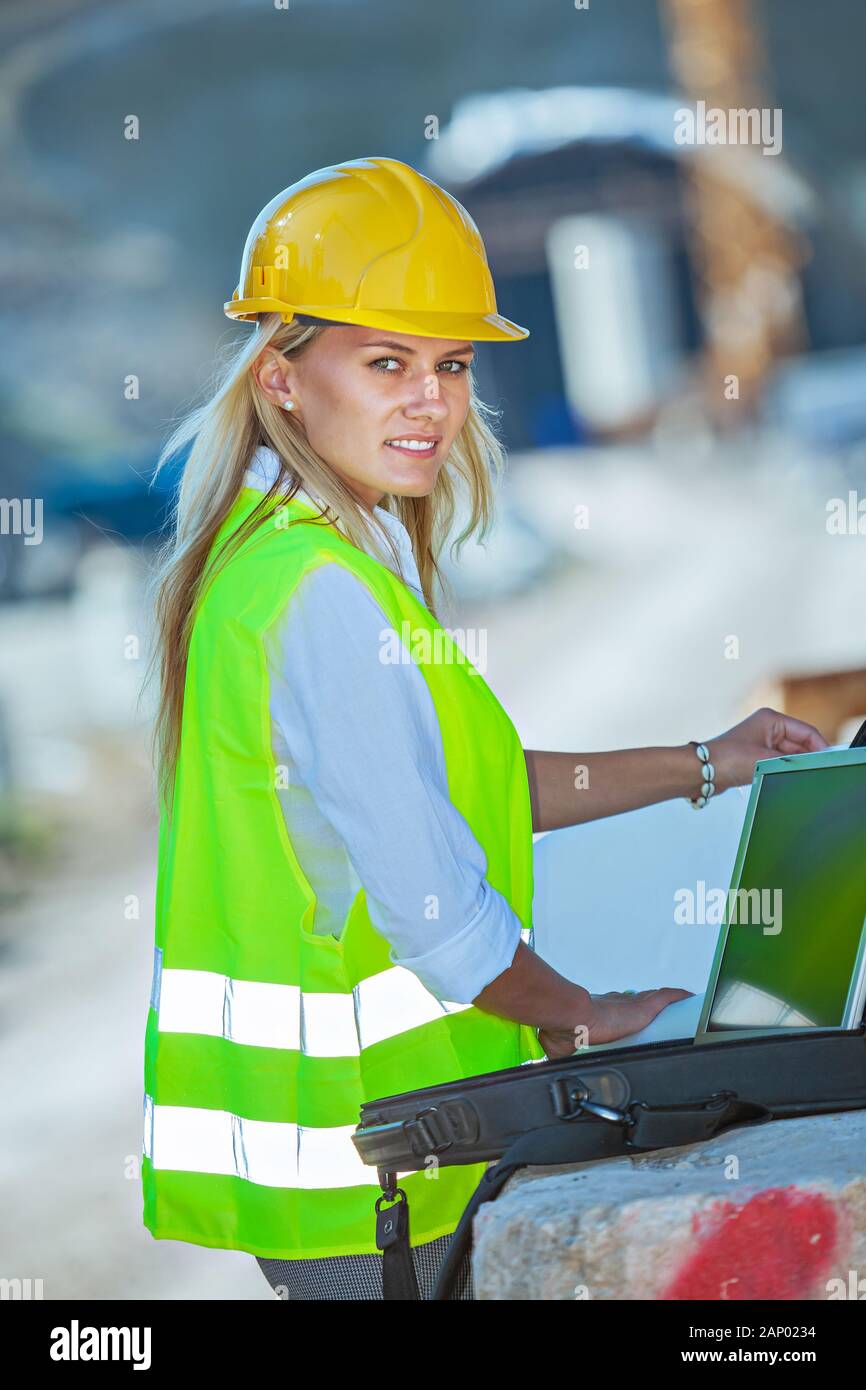 A young female constructor at building of a new motorway in Germany ...