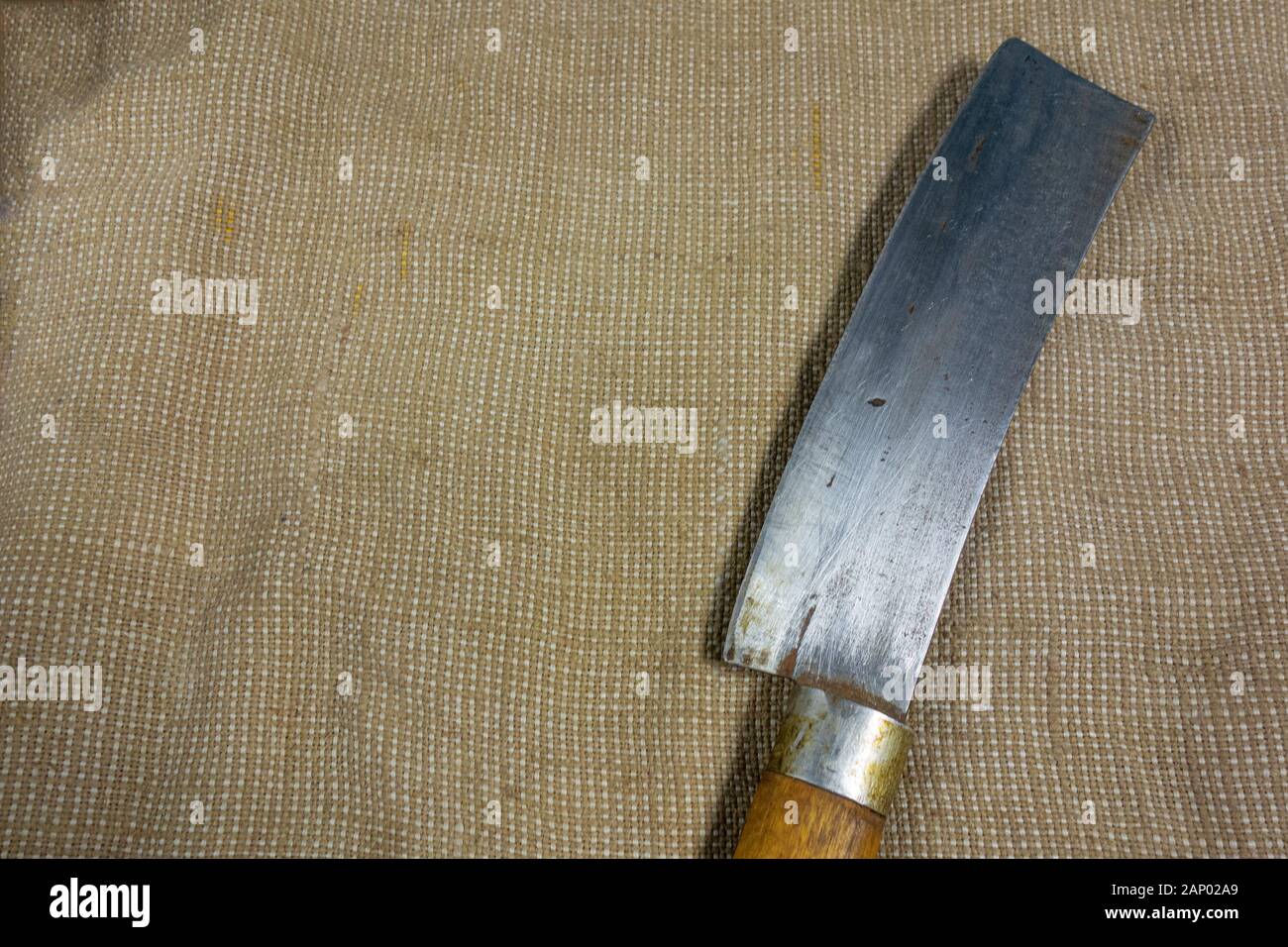 Big butcher knife on bagging fabric background. Closeup view of weapon ...