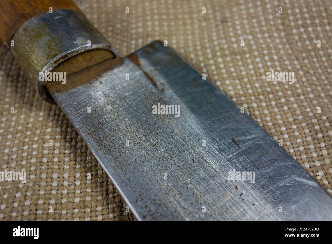 Big butcher knife on bagging fabric background. Closeup view of weapon ...