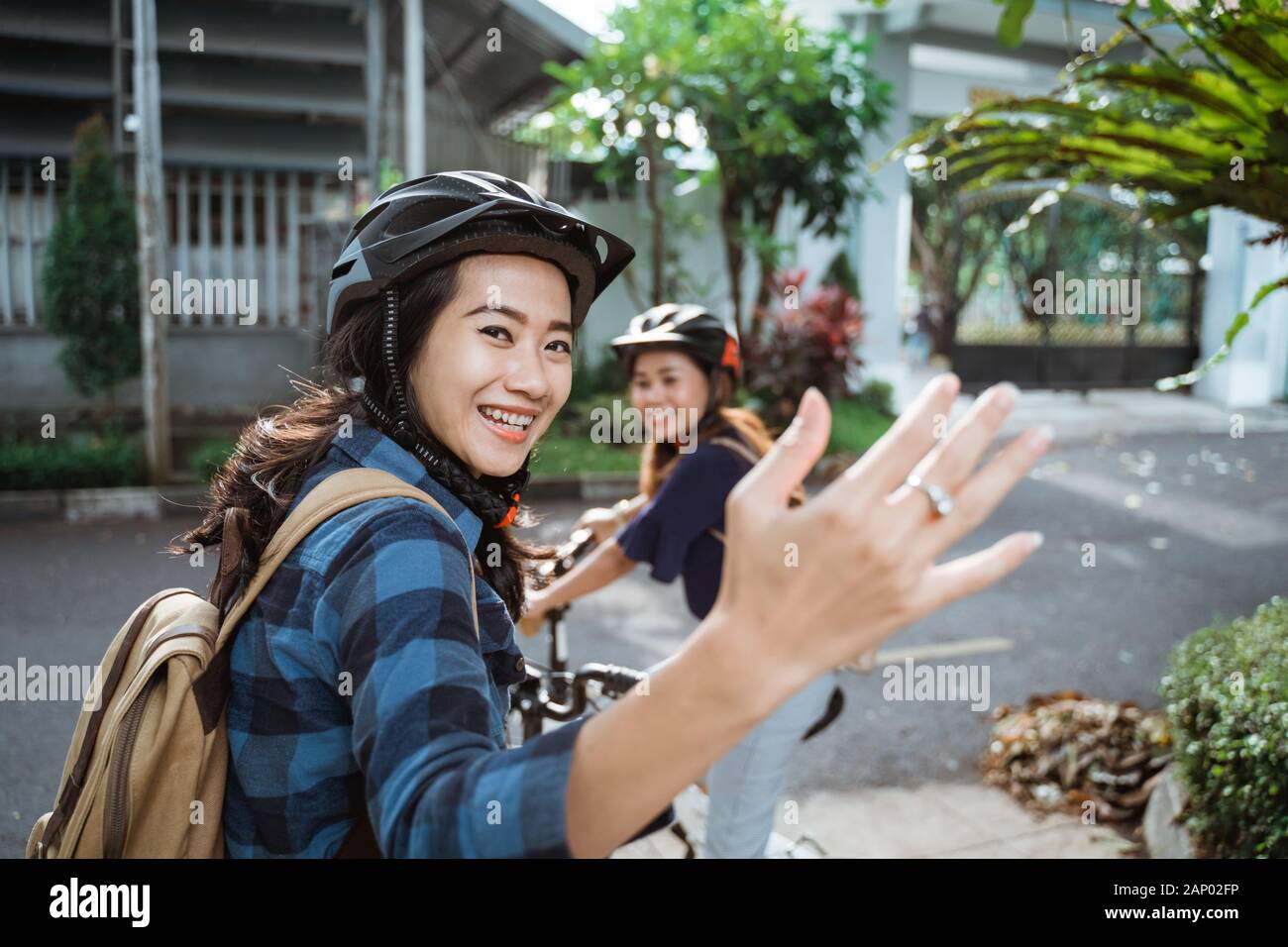 Two young girl are ready go to school with invite hand gestures Stock ...