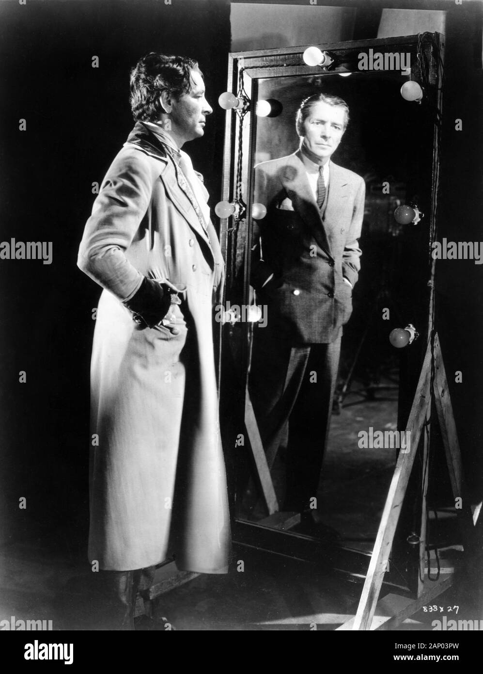 RONALD COLMAN as Sydney Carton looks at Reflection in Mirror of himself ...