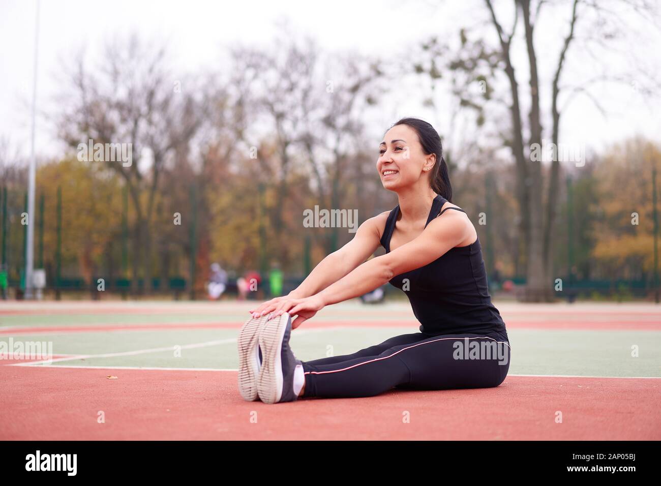 Happy girl doing fitness exercises outdoor on playground. Healthy ...