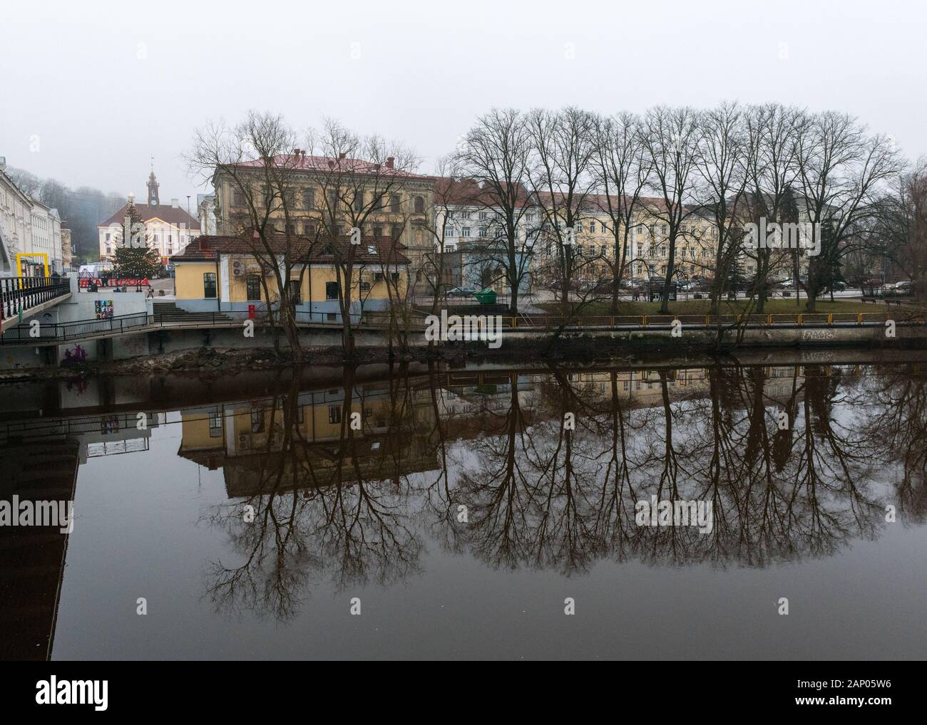 Buildings and trees reflected in the Emajõgi river in winter. Tartu ...