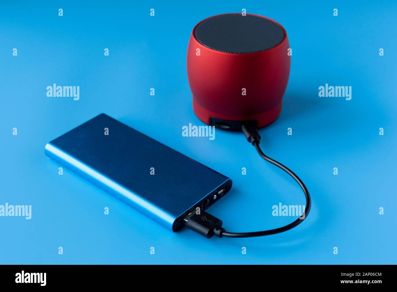 Power bank for charging mobile devices and devices. Blue smartphone ...