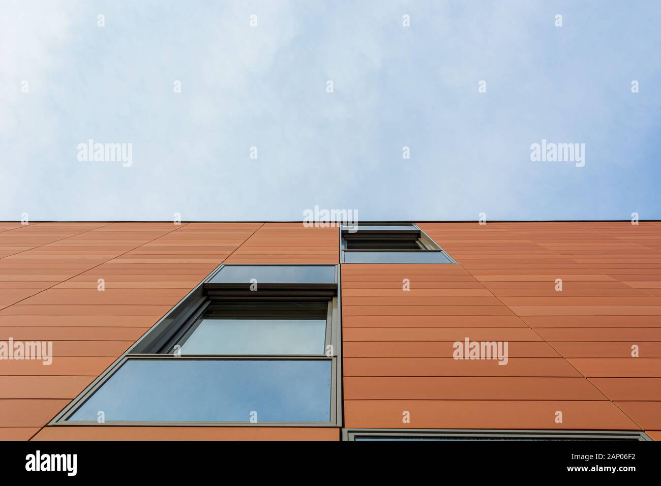 Architecture detail of modern building with orange facade and windows ...