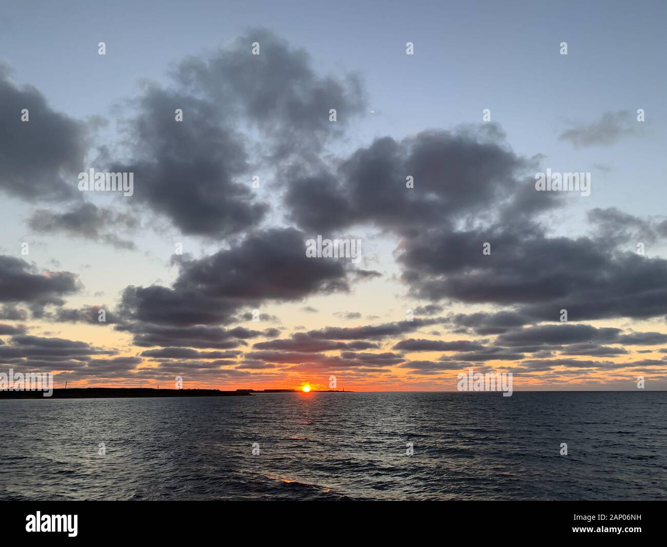 beautiful sunset sea landscape with clouds and sun Stock Photo - Alamy