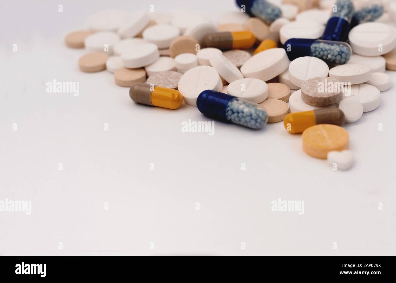 Heap of colorful pills in the shape of a heart, tablets and capsules on ...