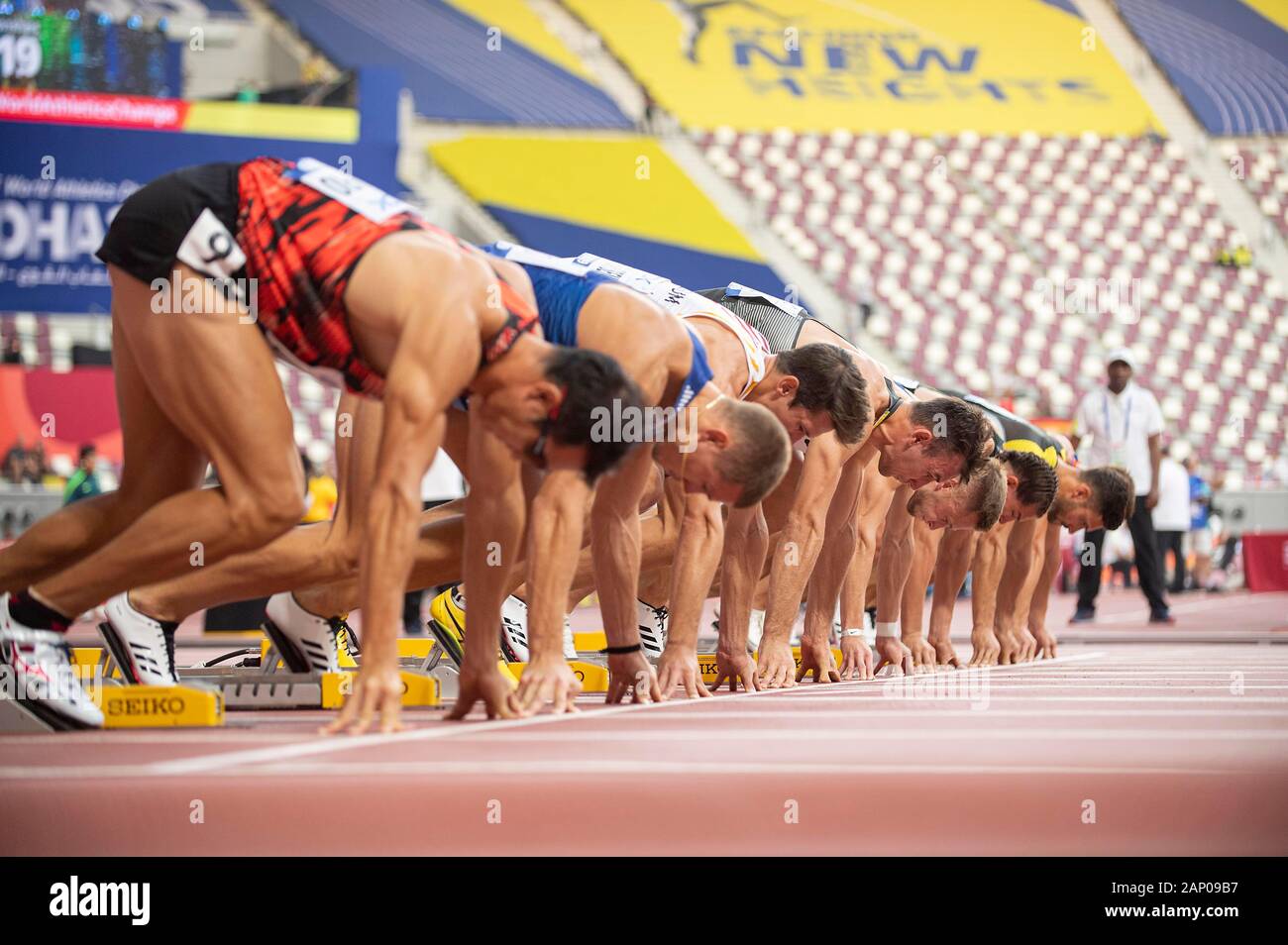 Feature, action, start, athletes in the starting block, hands on the ...