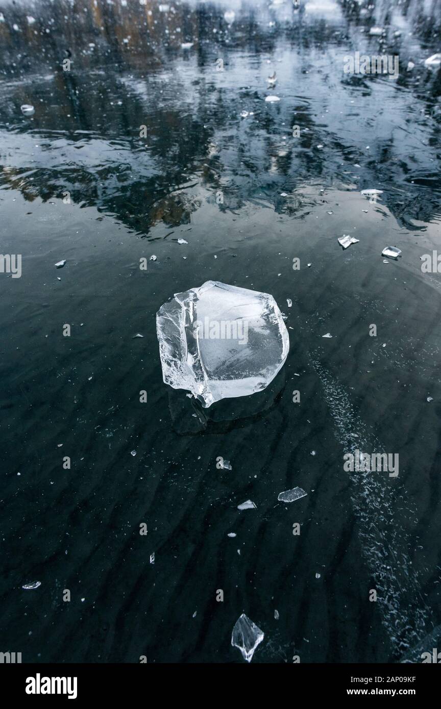 beaufiful clear chunk of ice on frozen lake Oeschinensee in the Bernese ...