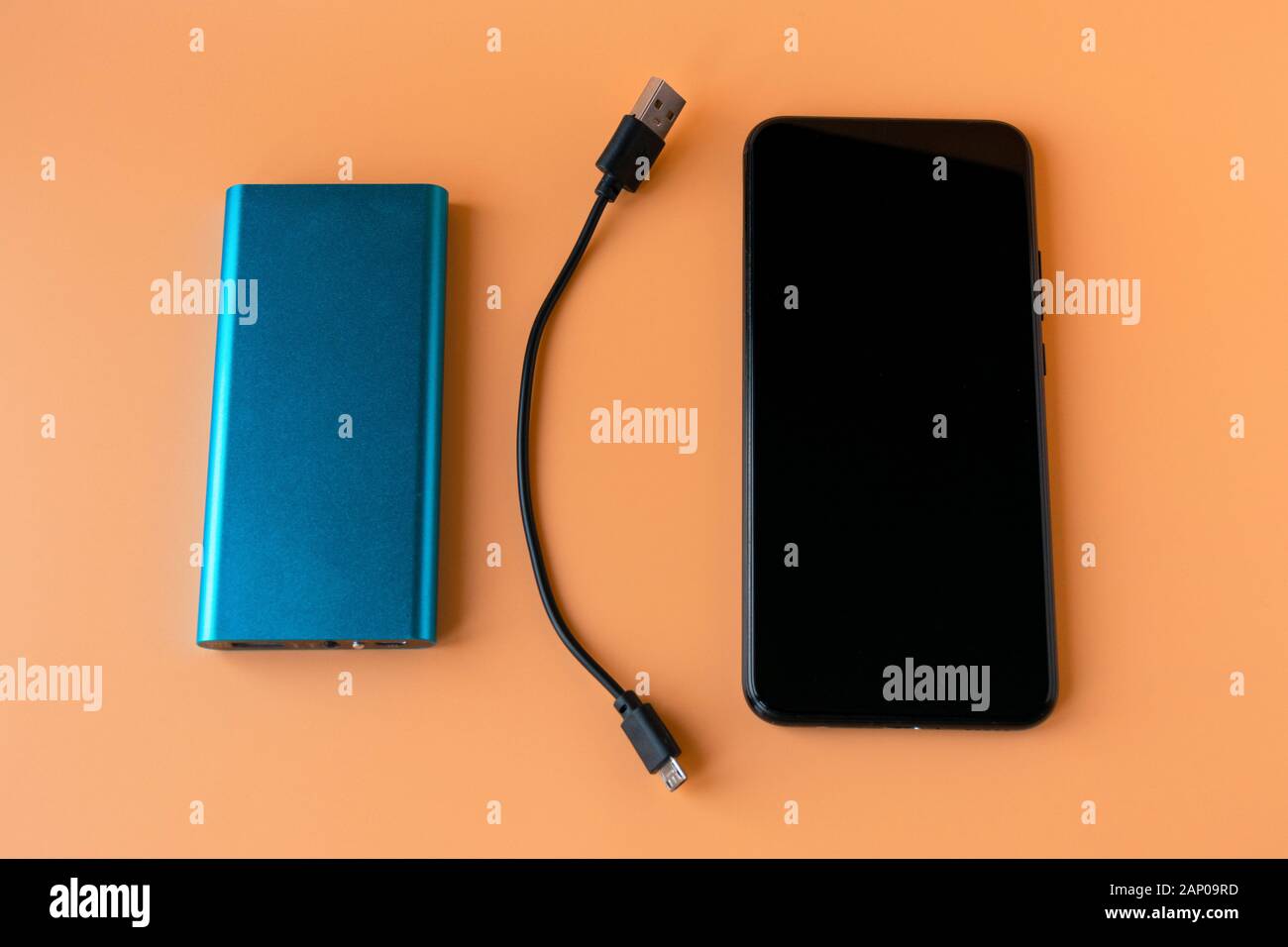 Power bank for charging mobile devices and devices. Blue smartphone ...