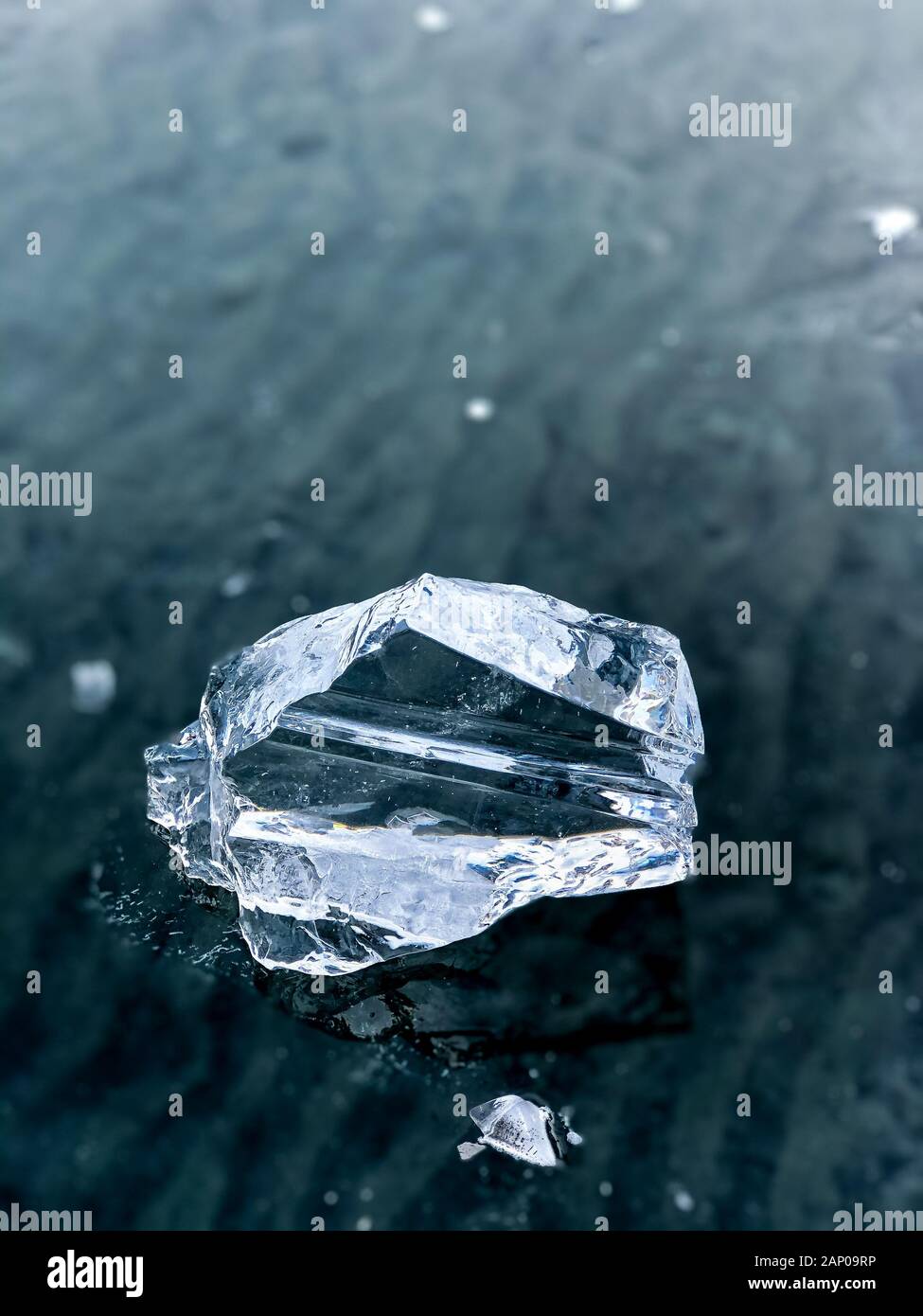 beaufiful clear chunk of ice on frozen lake Oeschinensee in the Bernese ...
