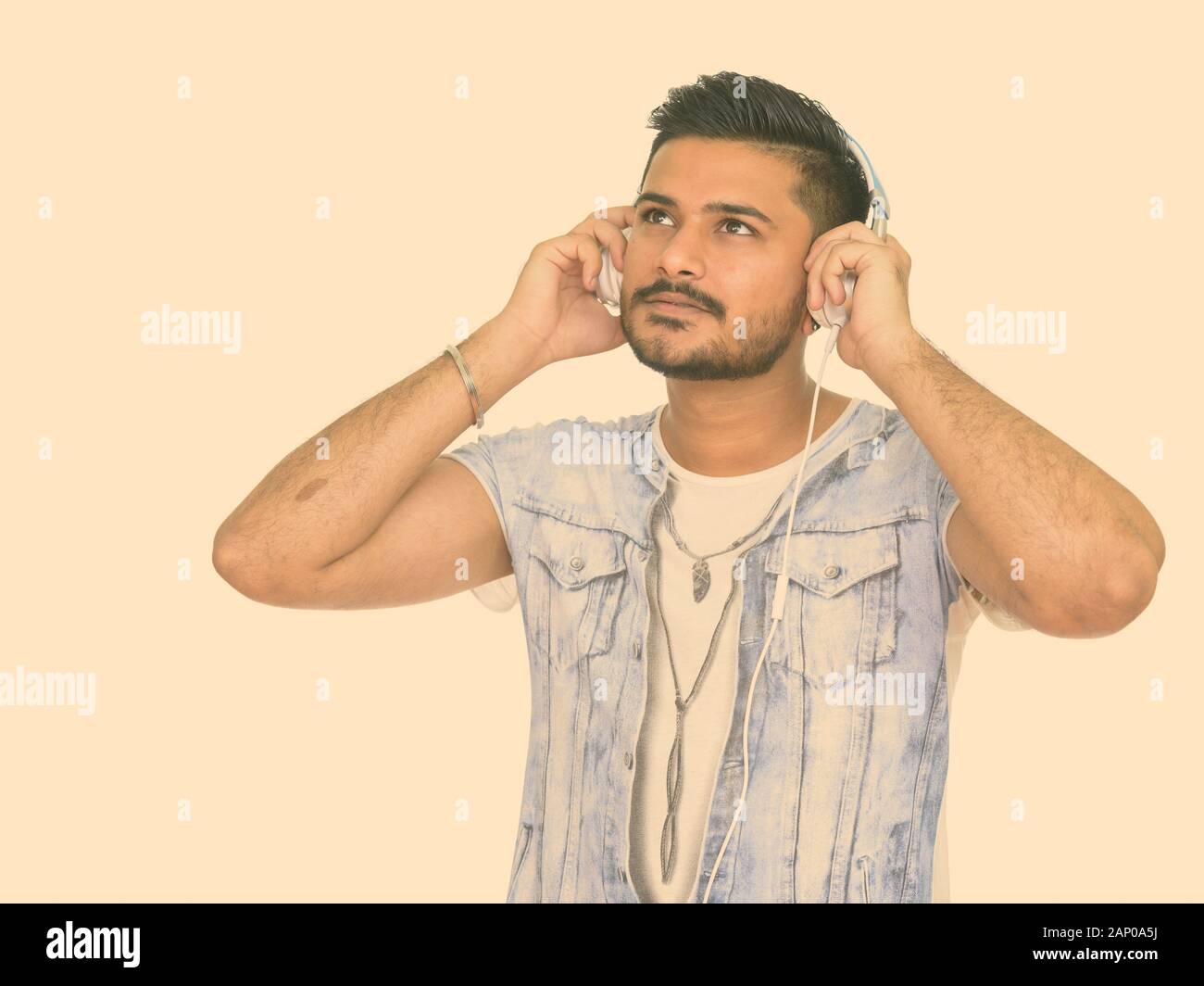 Young handsome Indian man listening to music Stock Photo - Alamy