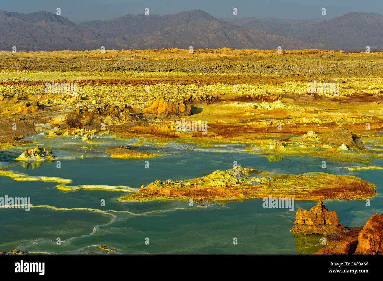 Volcanic landscape with sulphure rock formations and an acid brine pool ...