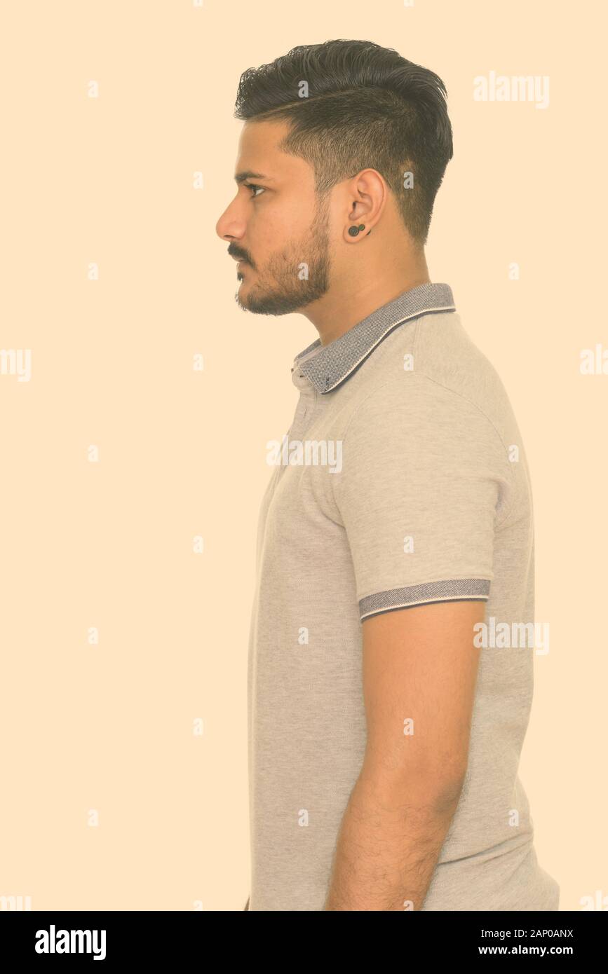 Profile view of young handsome bearded Indian man Stock Photo - Alamy