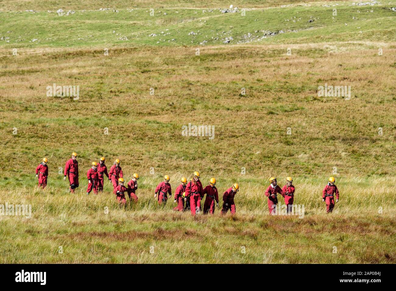 School children and their guides return from exploring a cave at ...