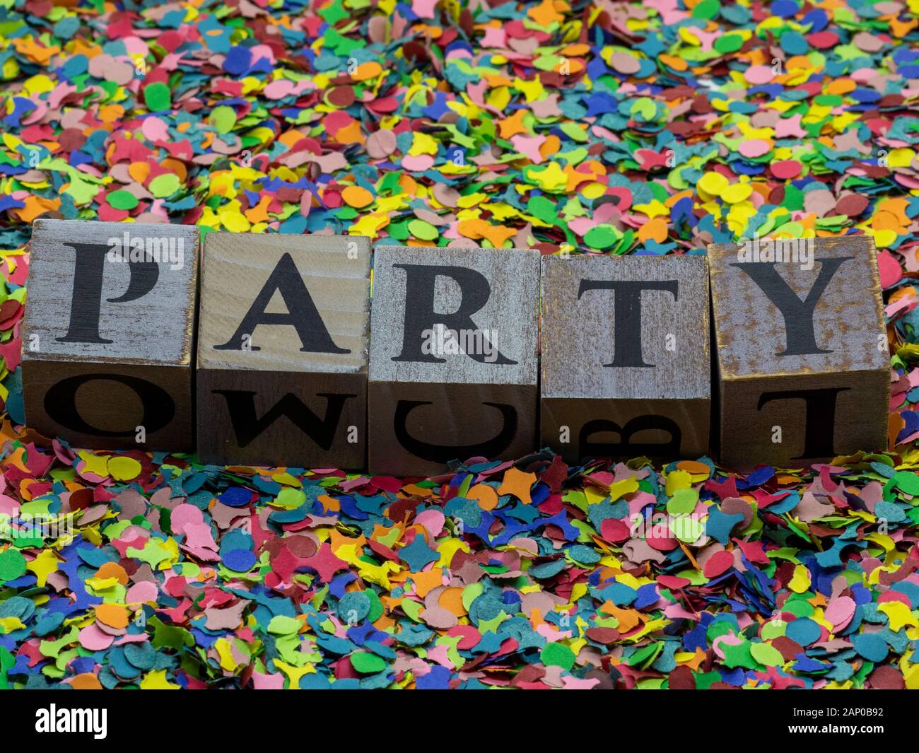 "Party" written on wooden blocks isolated on confetti background Stock ...
