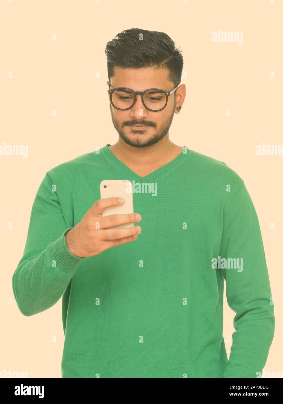 Young handsome Indian man using mobile phone Stock Photo - Alamy
