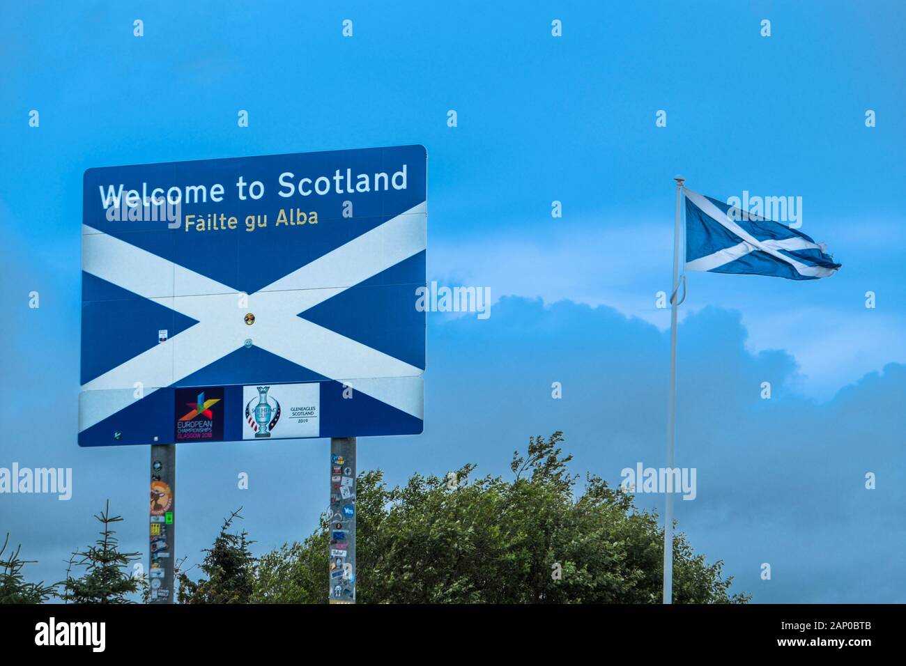 Roadside sign and cross of St Andrew flag welcoming visitors to ...