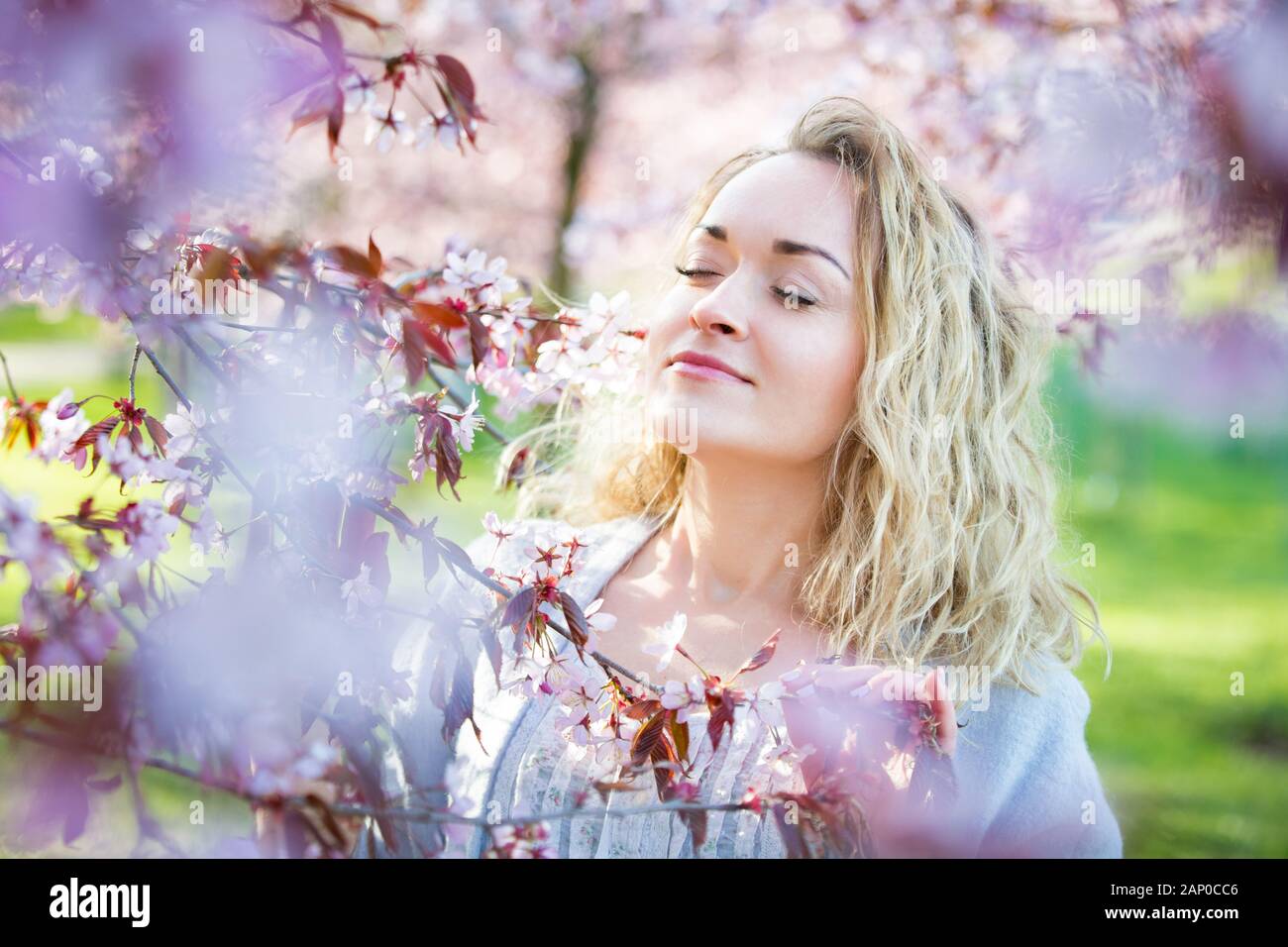 Young woman enjoying the nature in spring. Breathing fresh air and ...