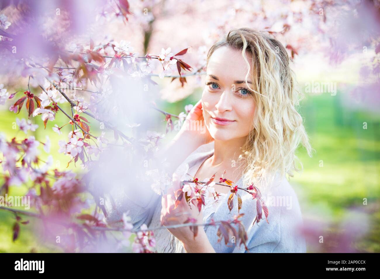 Young woman enjoying the nature in spring. Breathing fresh air and ...