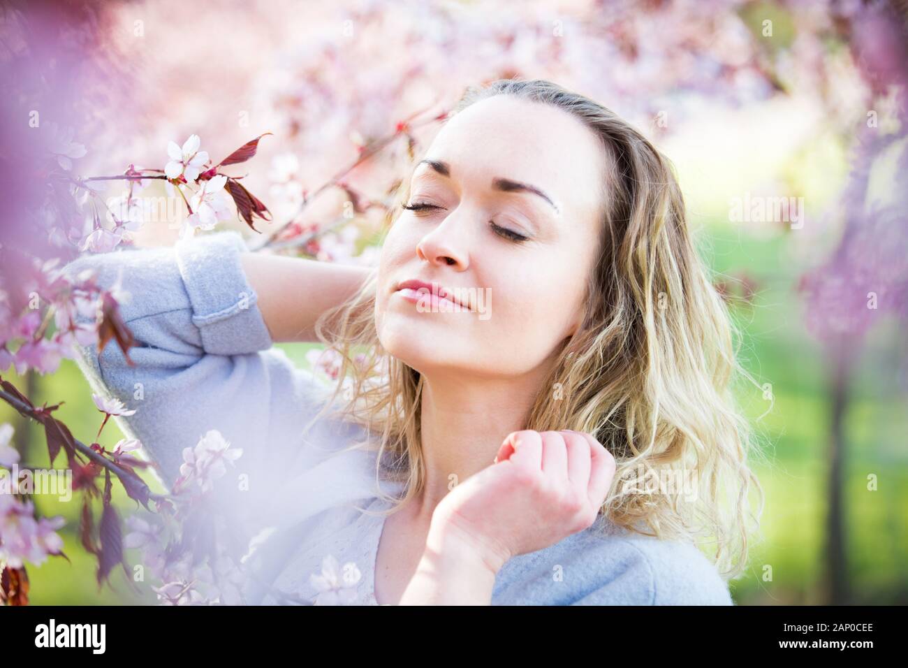 Young woman enjoying the nature in spring. Breathing fresh air and ...