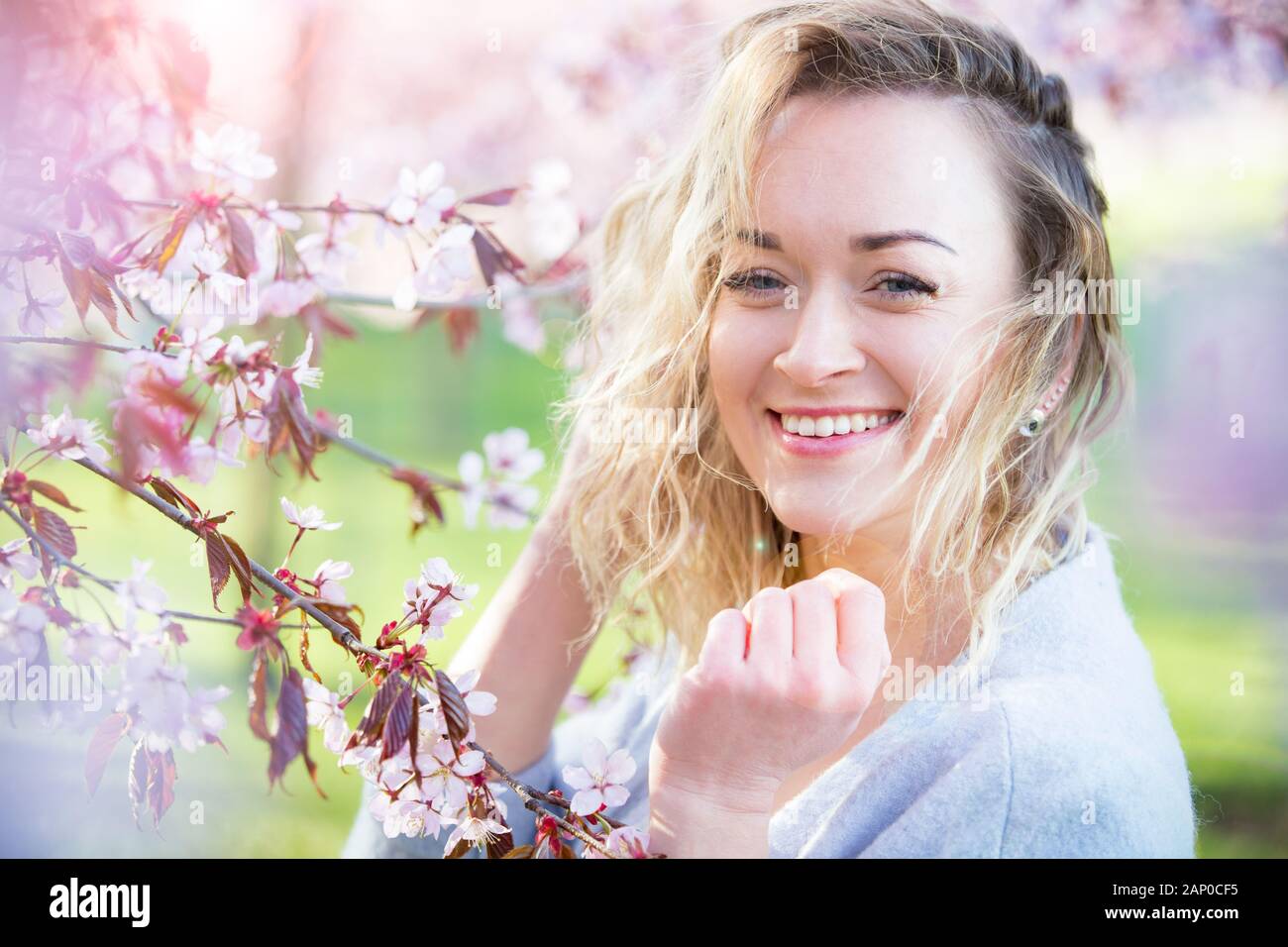 Young woman enjoying the nature in spring. Breathing fresh air and ...