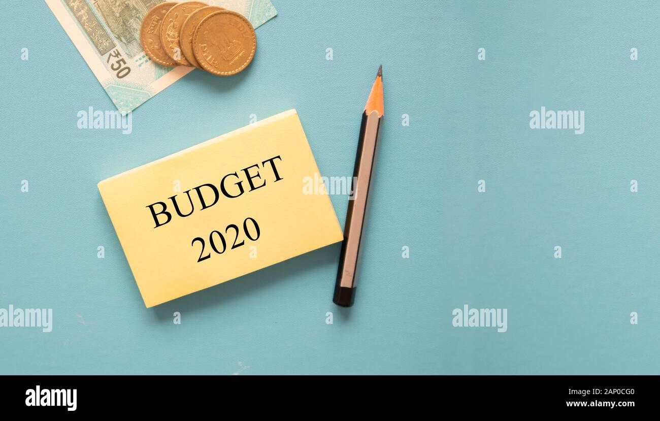 Concept of Budget 2020 with Indian Currency notes and coins on blue ...