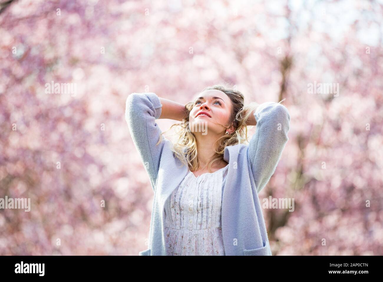 Young woman enjoying the nature in spring. Dancing, running and ...