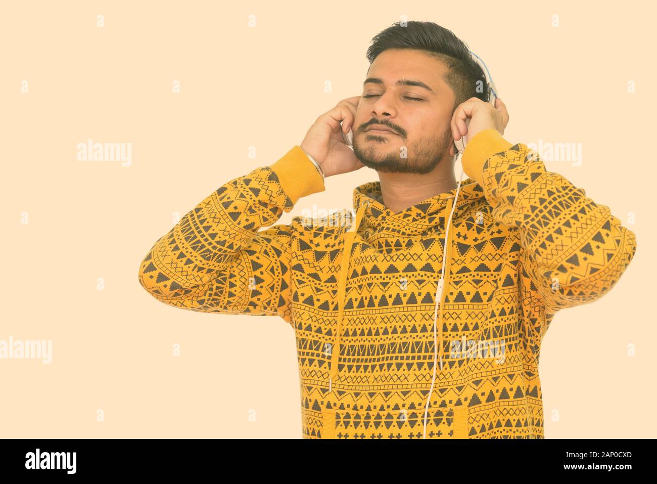 Young handsome Indian man listening to music Stock Photo - Alamy