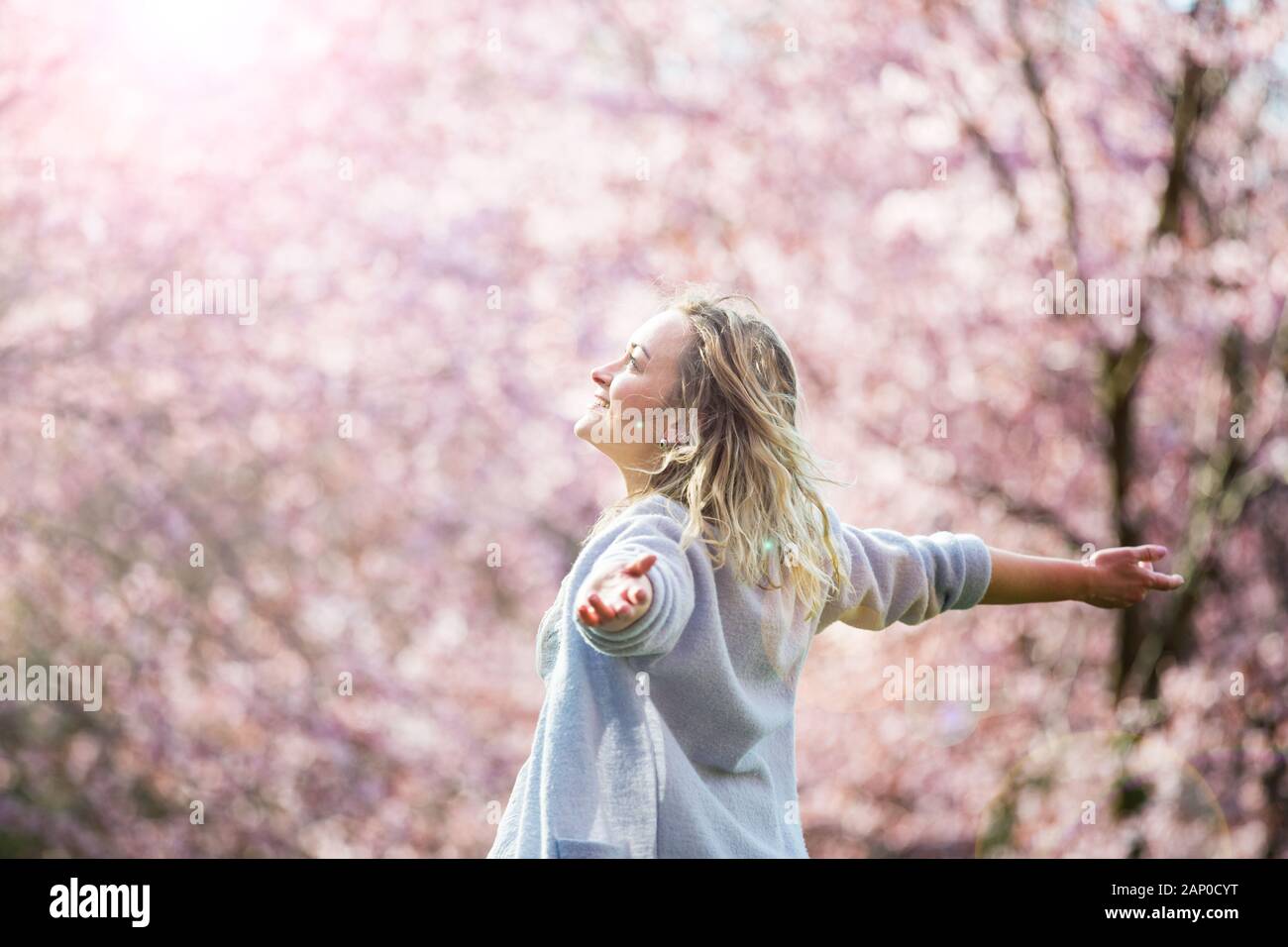 Young woman enjoying the nature in spring. Dancing, running and ...