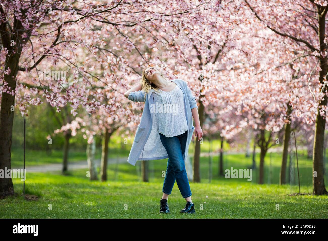 Young woman enjoying the nature in spring. Dancing, running and ...