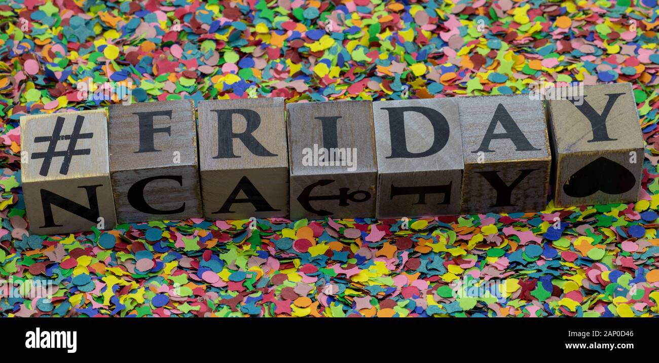 "# Friday" written on wooden blocks isolated on confetti background ...