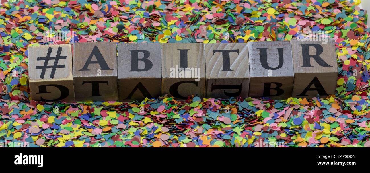 "Abitur" written on wooden blocks isolated on confetti background Stock ...