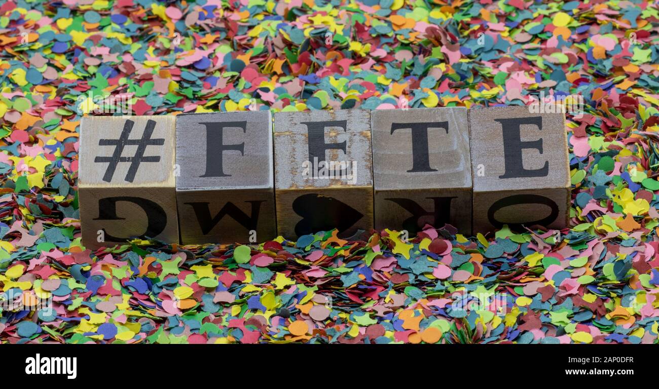"# Fete" written on wooden blocks isolated on confetti background Stock ...