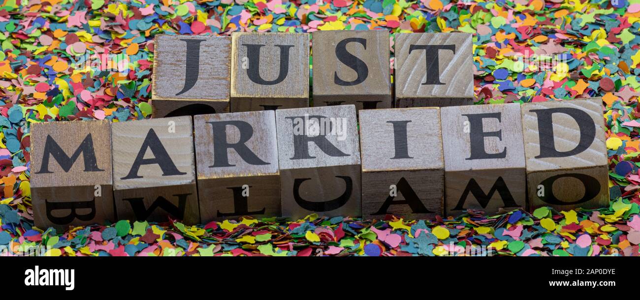 "Just married" written on wooden blocks and isolated on a confetti ...