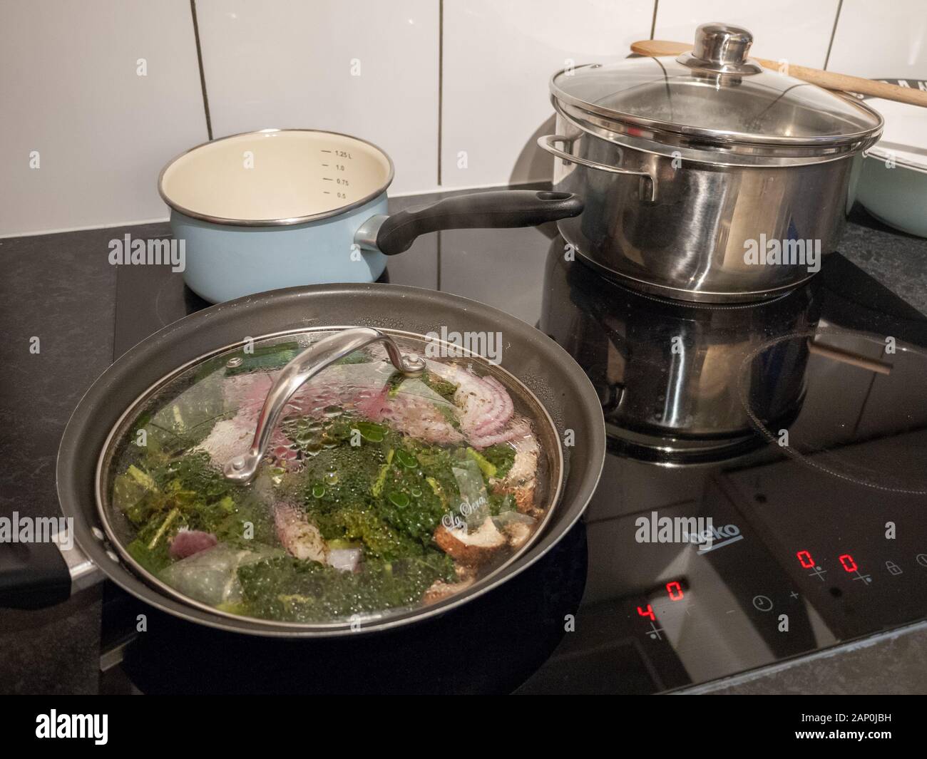 Food cooking atop a hob stove inside kitchen close up; England; UK ...