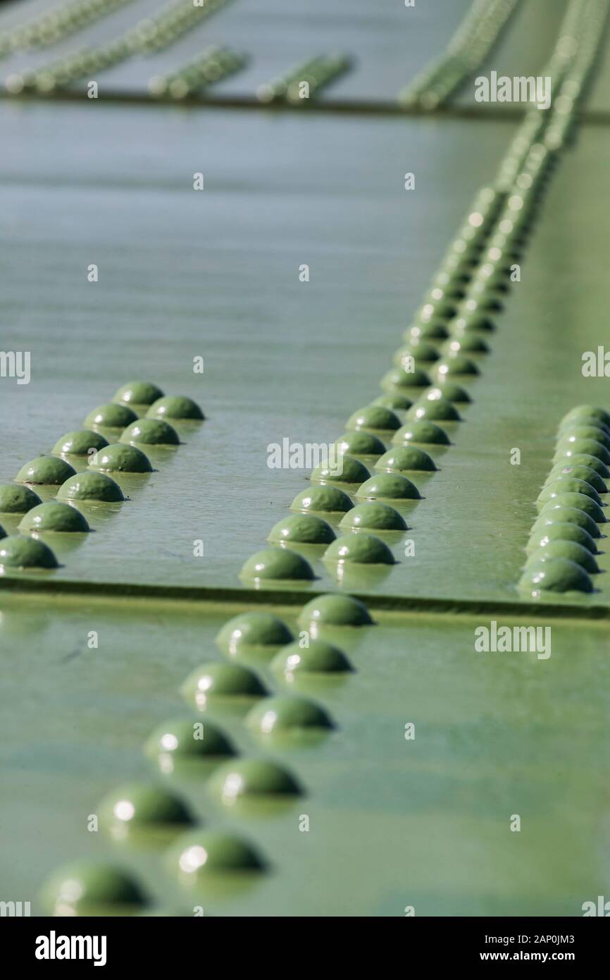 Metal parts of the rivet joints and bolts of the bridge construction ...