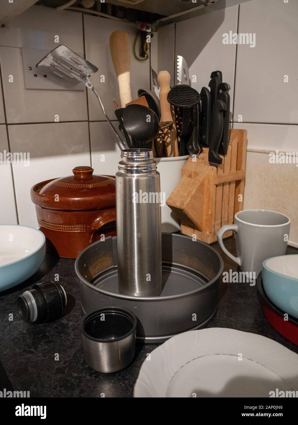 freshly washed kitchen utensils on side board in kitchen home; England ...