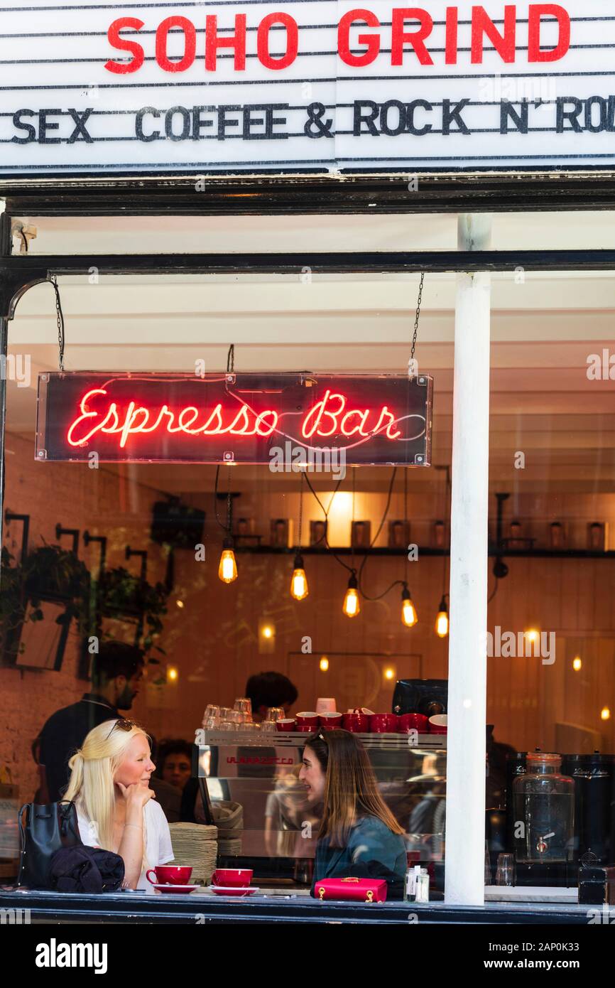 Two young women having coffee inside the Soho Grind espresso and ...