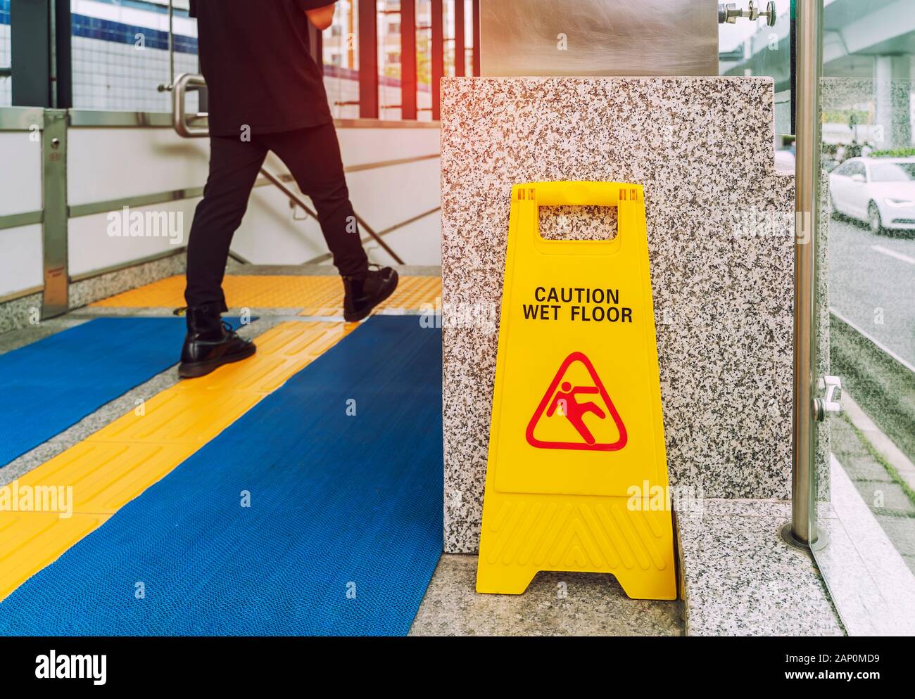 Yellow Caution wet floor sign on wet floor Stock Photo - Alamy