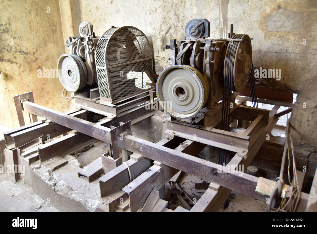 Running electric motor of an elevator and its support structure on ...