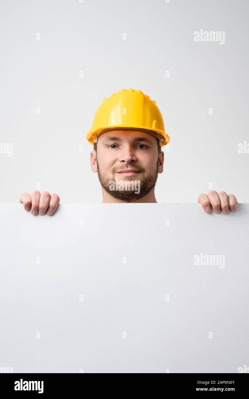 Worker holding blank board on white background Stock Photo - Alamy