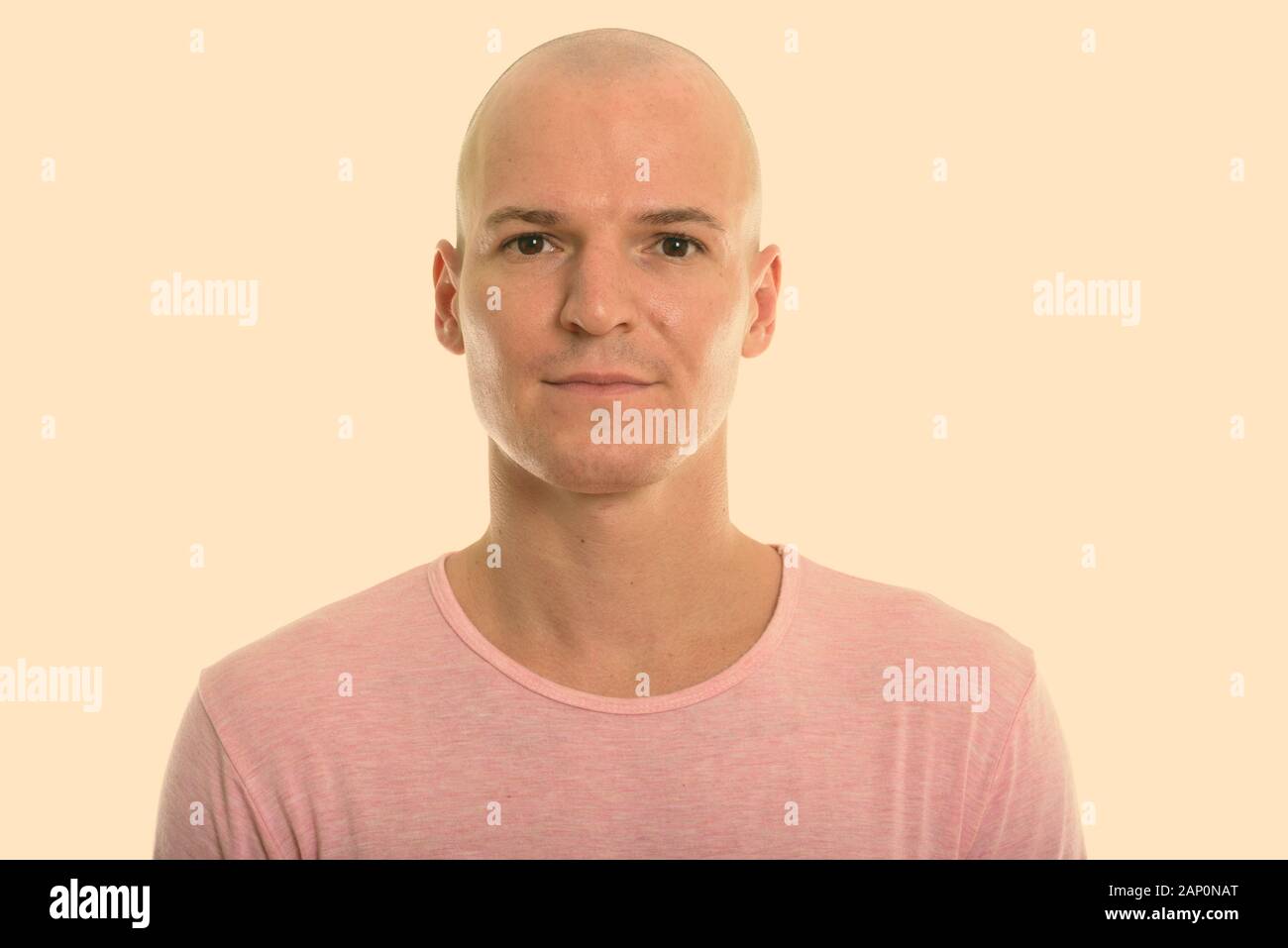 Studio shot of young handsome bald man isolated against white ...