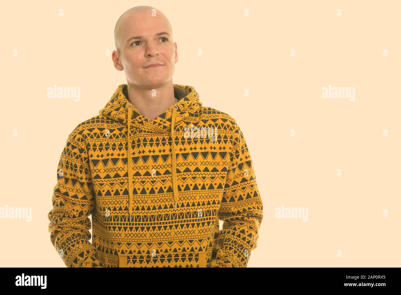 Studio shot of young handsome bald man isolated against white ...