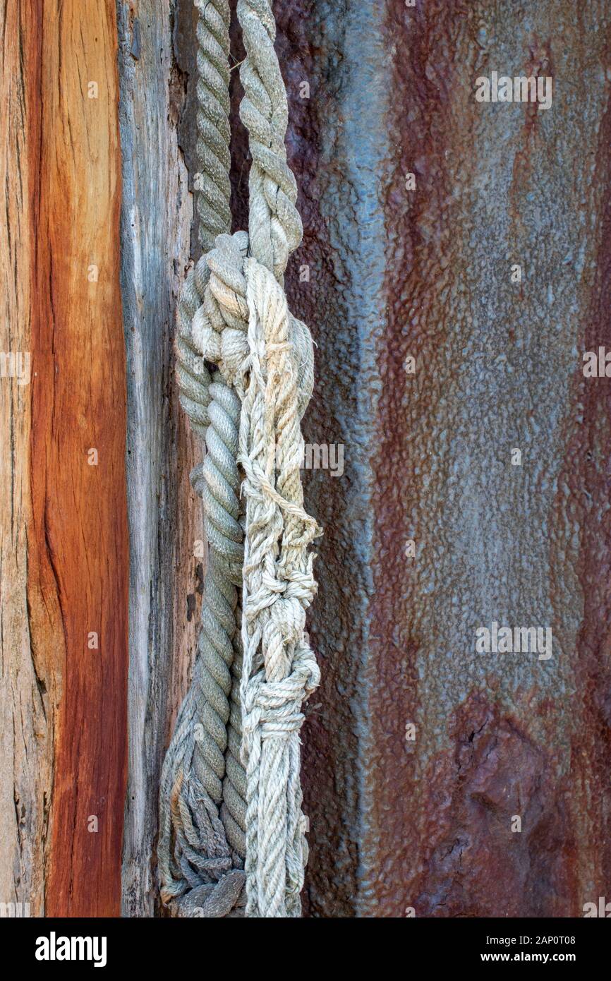 Old nautical rope hanging from a weathered wooden post at Old Leigh ...