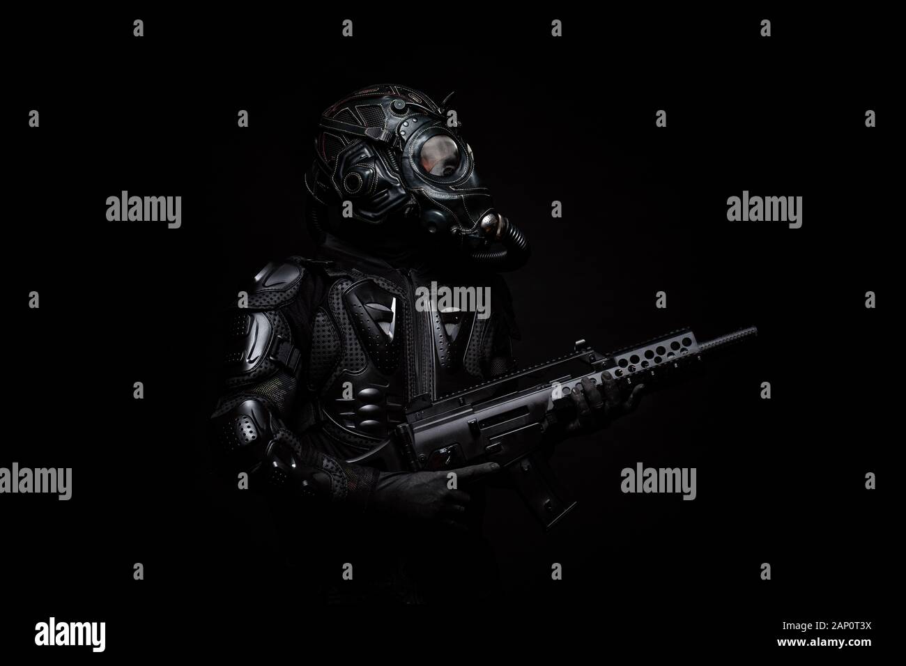 Futuristic warrior a machine gun in his hands Stock Photo - Alamy